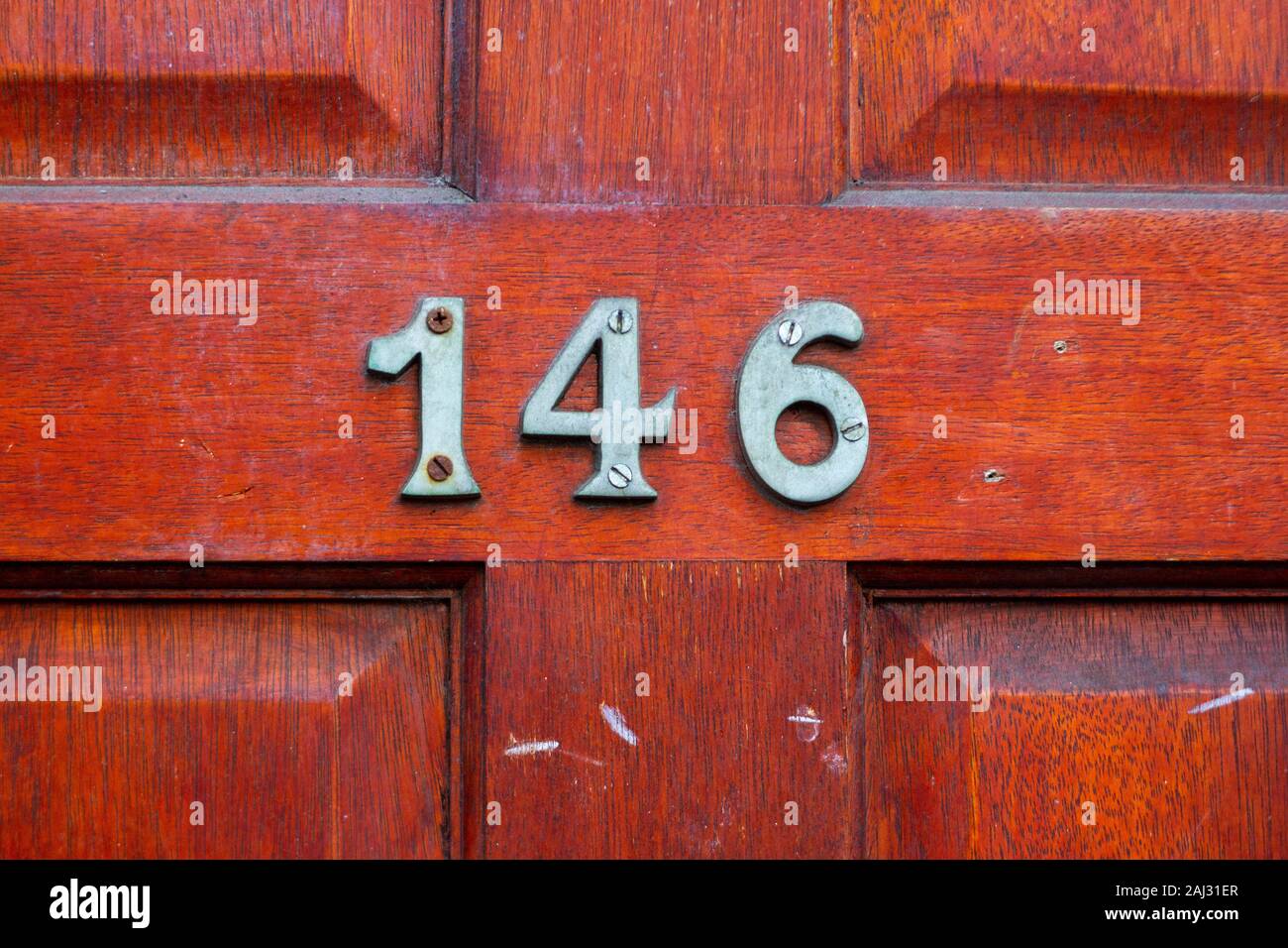 House number 146 on a simple wooden front door Stock Photo - Alamy