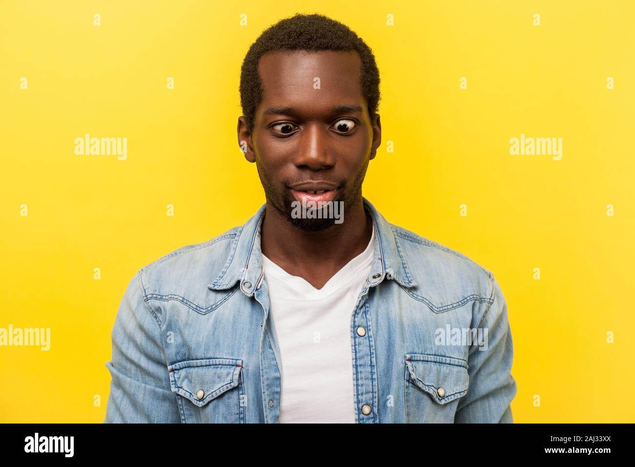 Portrait of silly funny positive man in denim casual shirt crossing ...