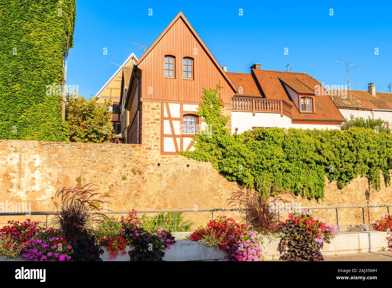 Traditional houses in famous Riquewihr village, Alsace wine route ...