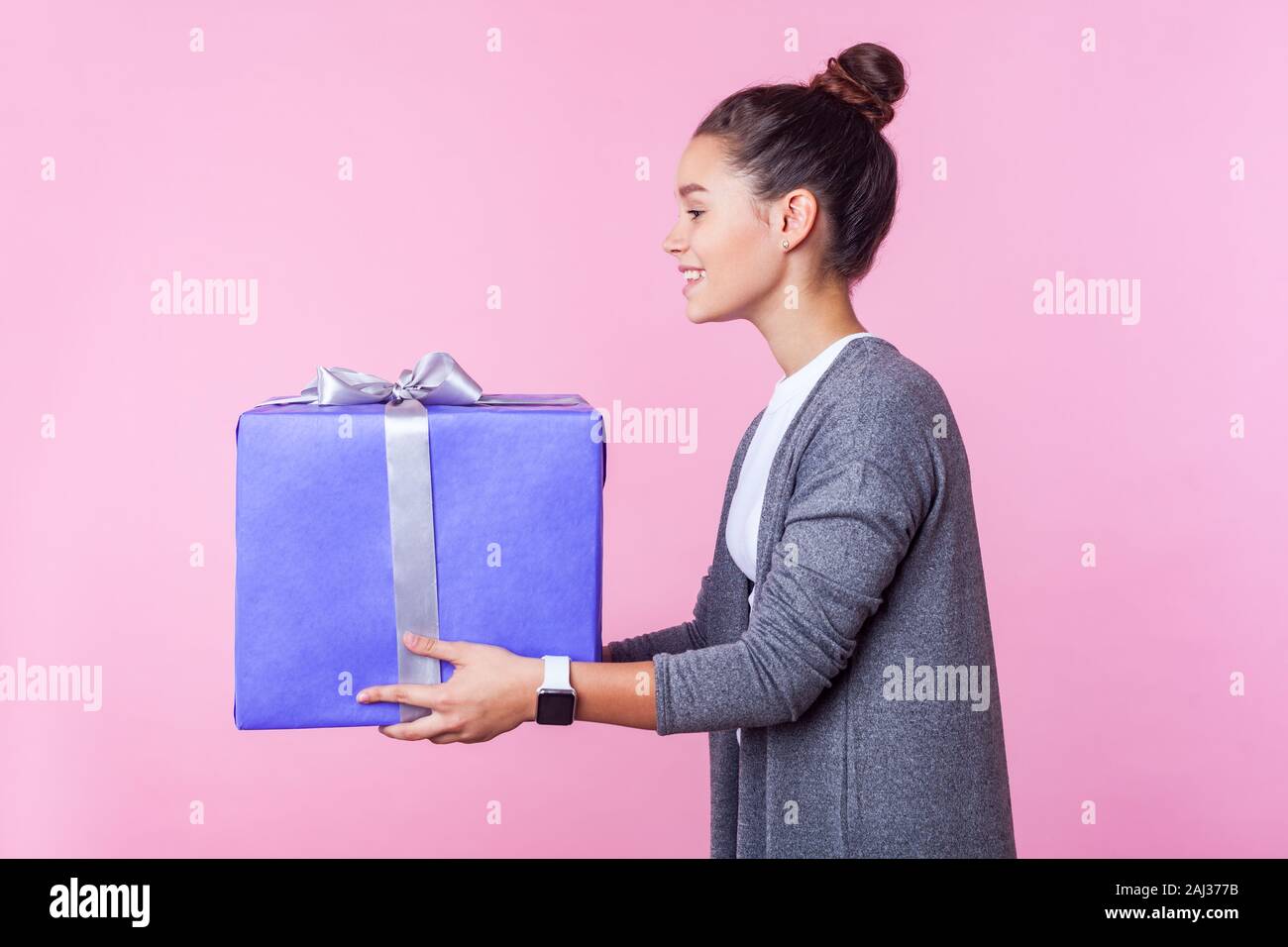 Charity donation. Side view of generous teen brunette girl with bun ...