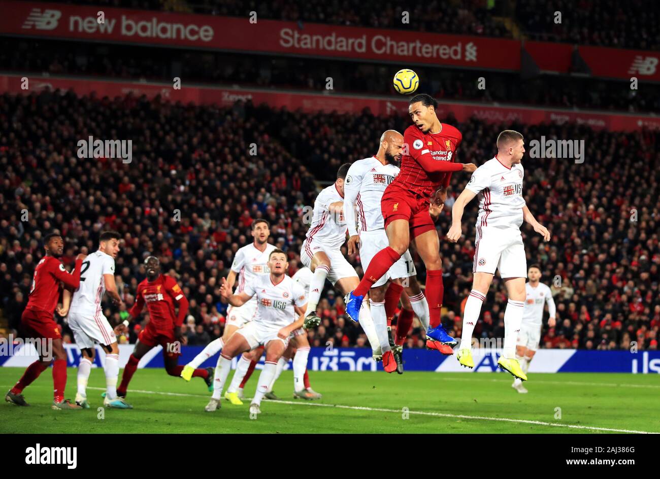 Liverpool's Virgil van Dijk (second right) wins a header during the ...