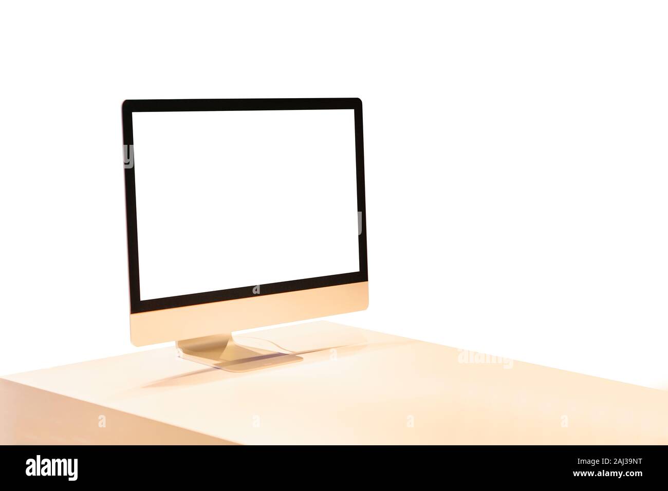 Modern personal computer on a wooden table with a white white screen ...