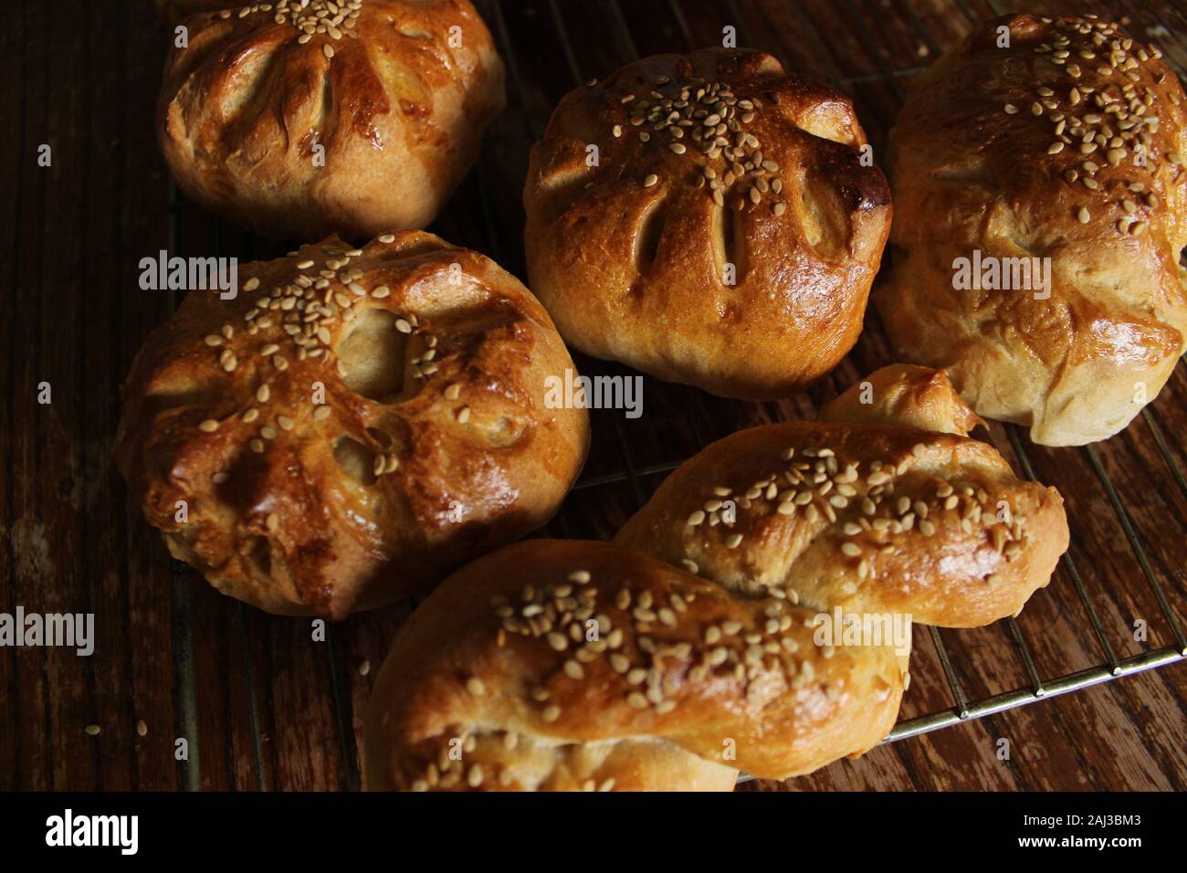 Baked, glazed, pleated and cut sesame seed bread buns Stock Photo - Alamy