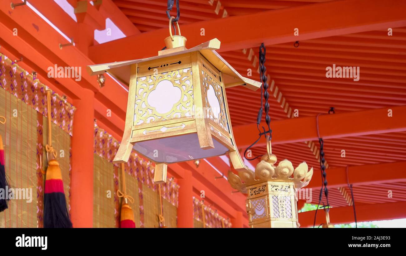a gold colored lantern at fushimi inari shrine in kyoto Stock Photo - Alamy