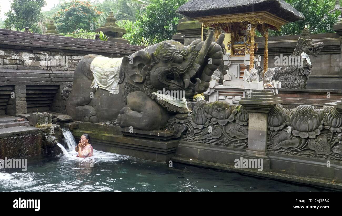 MANUKAYA, INDONESIA- MARCH,22, 2018: woman bathing at holy spring ...