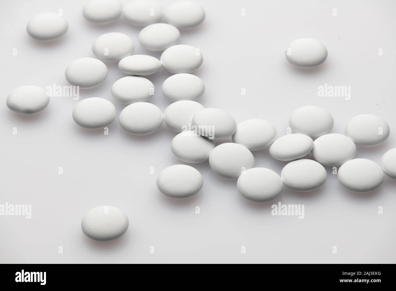Group of white pills on white background - healthcare and medicament ...