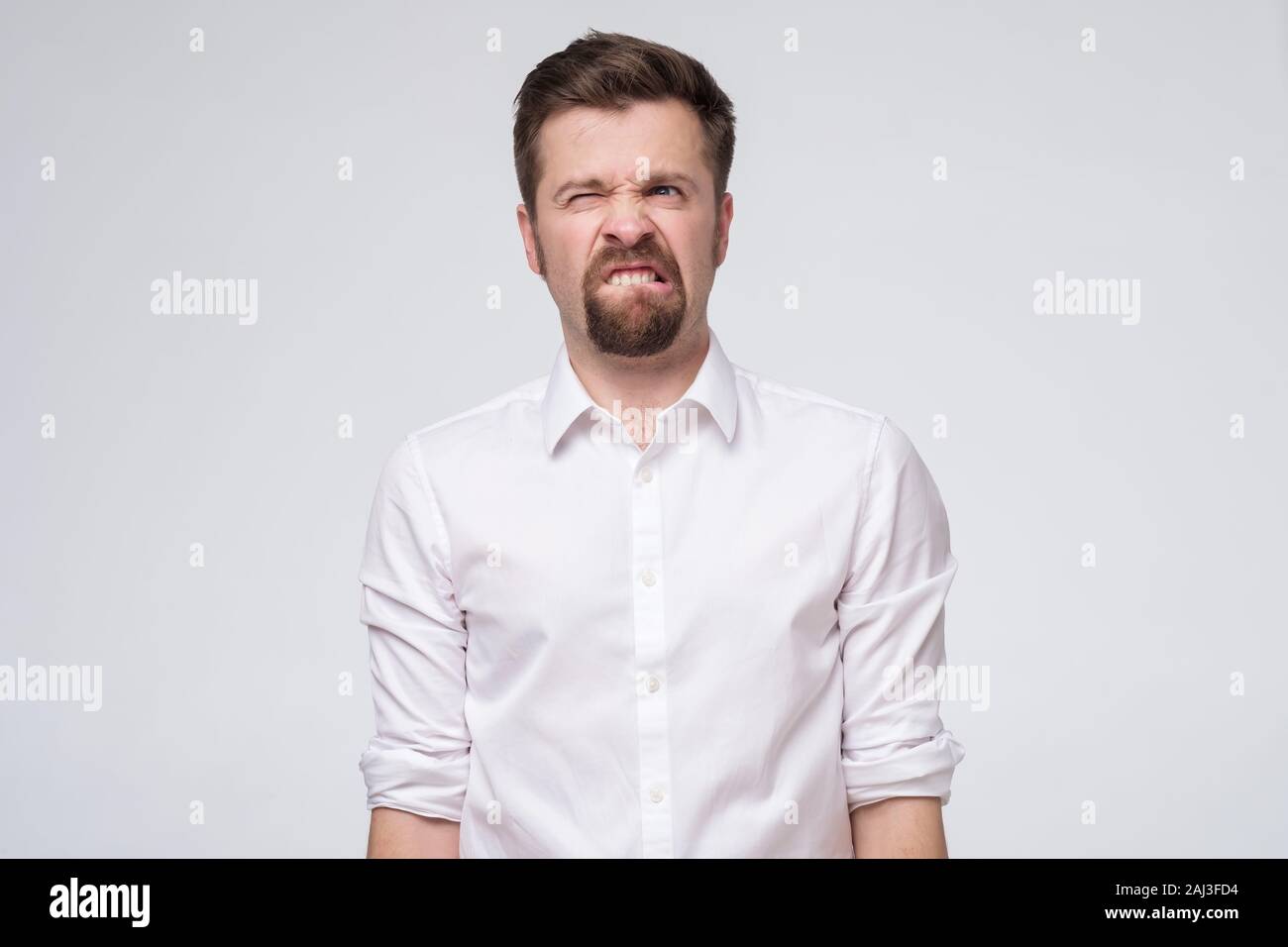 Scared young caucasian man biting lips, feeling nervous and impatient ...