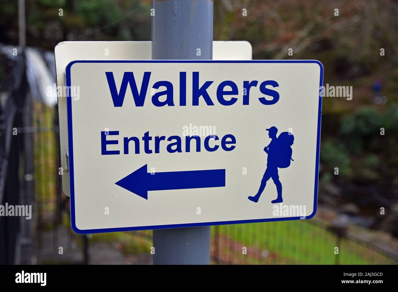 Walkers entrance sign with arrow pointing left and backpacker symbol ...