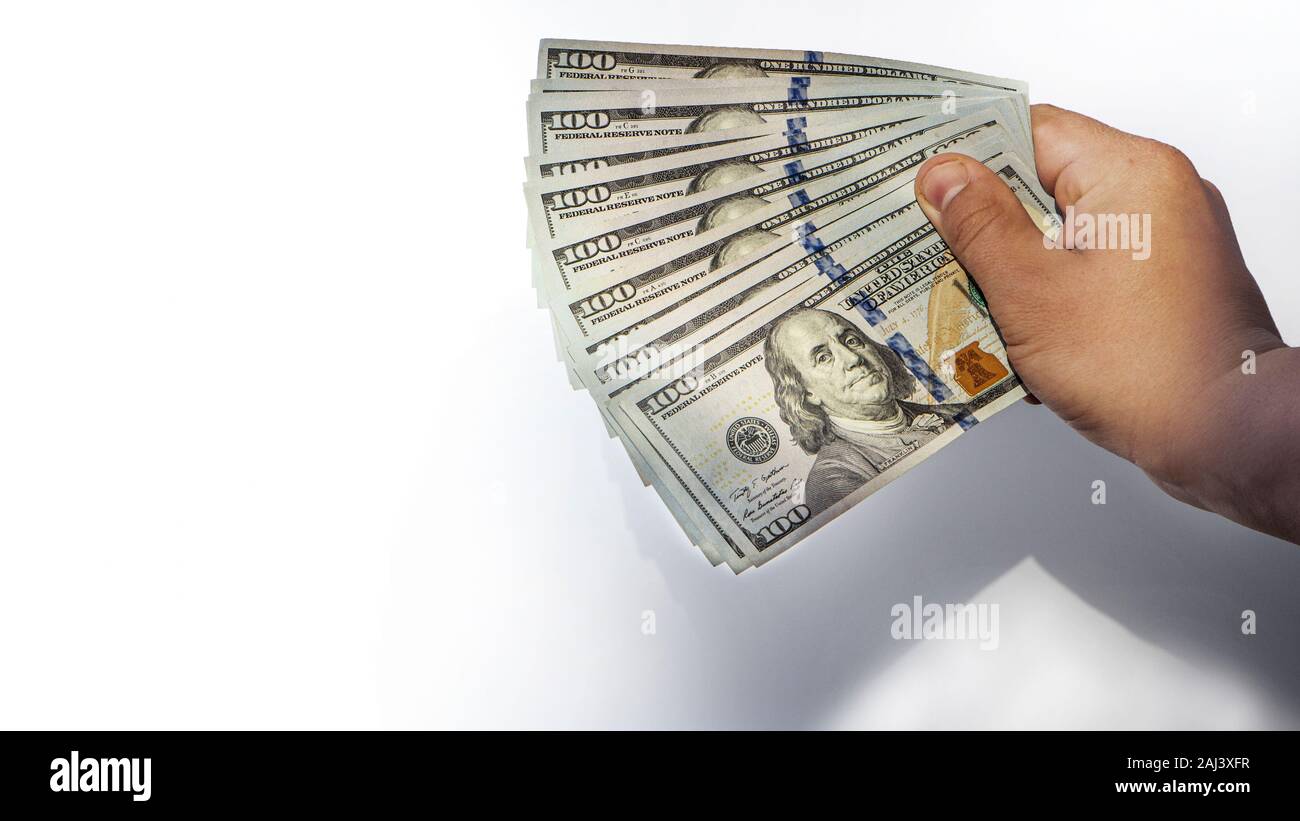 100 dollar banknote in hand shadow falling on white background Stock ...