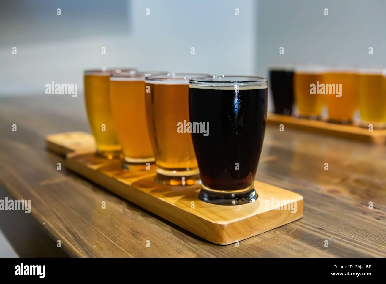Flight of craft four of different beers glasses with black beer on a ...