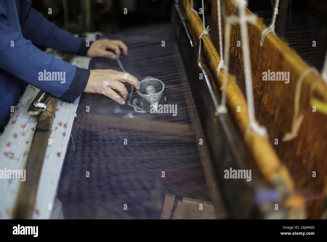 Gaza City, Palestine. 2nd Jan, 2020. A Palestinian worker weaves ...