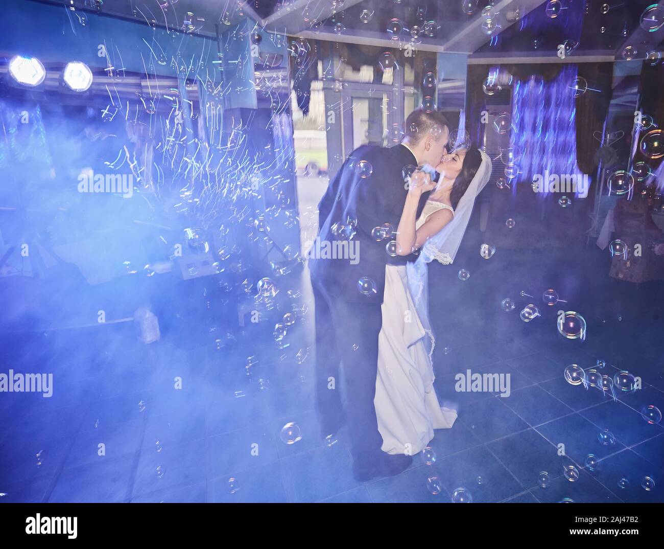 beautiful caucasian couple just married and dancing their first dance ...