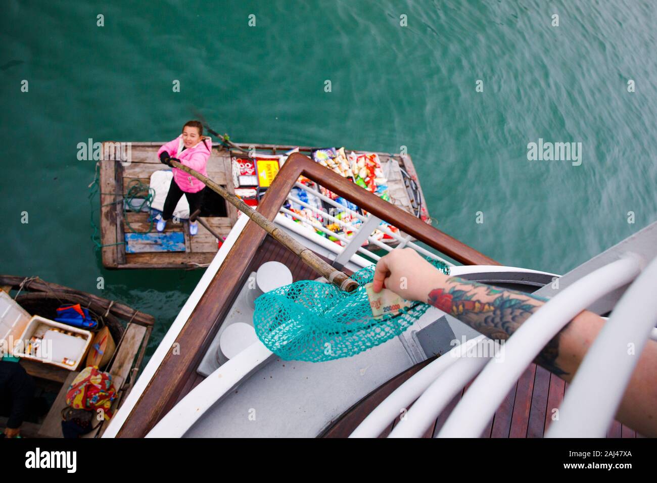 Floating sales people approaching cruise ships selling goods - Ha Long ...