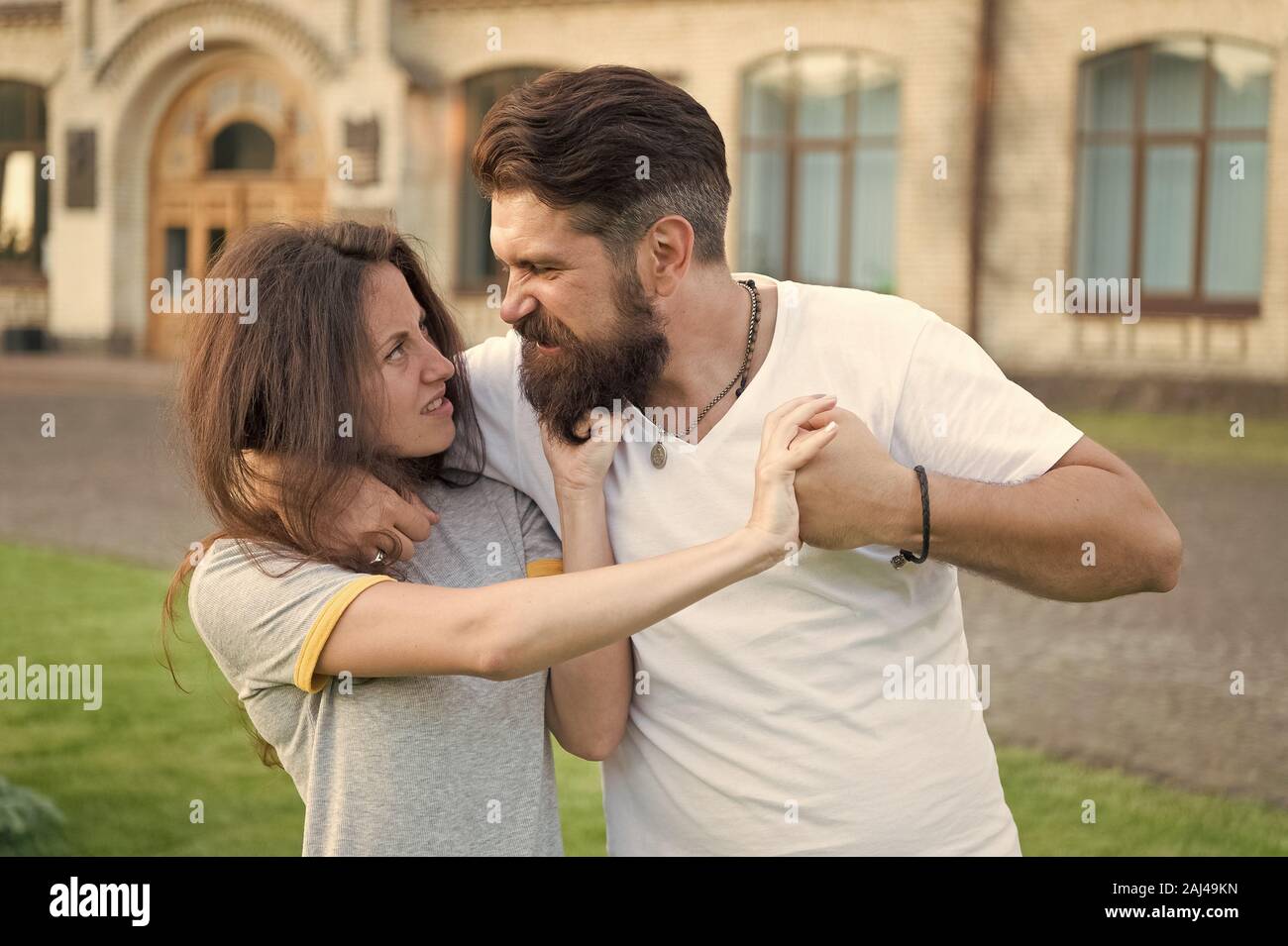 Stop it. Brutal hipster fighting with pretty woman. Violence concept ...