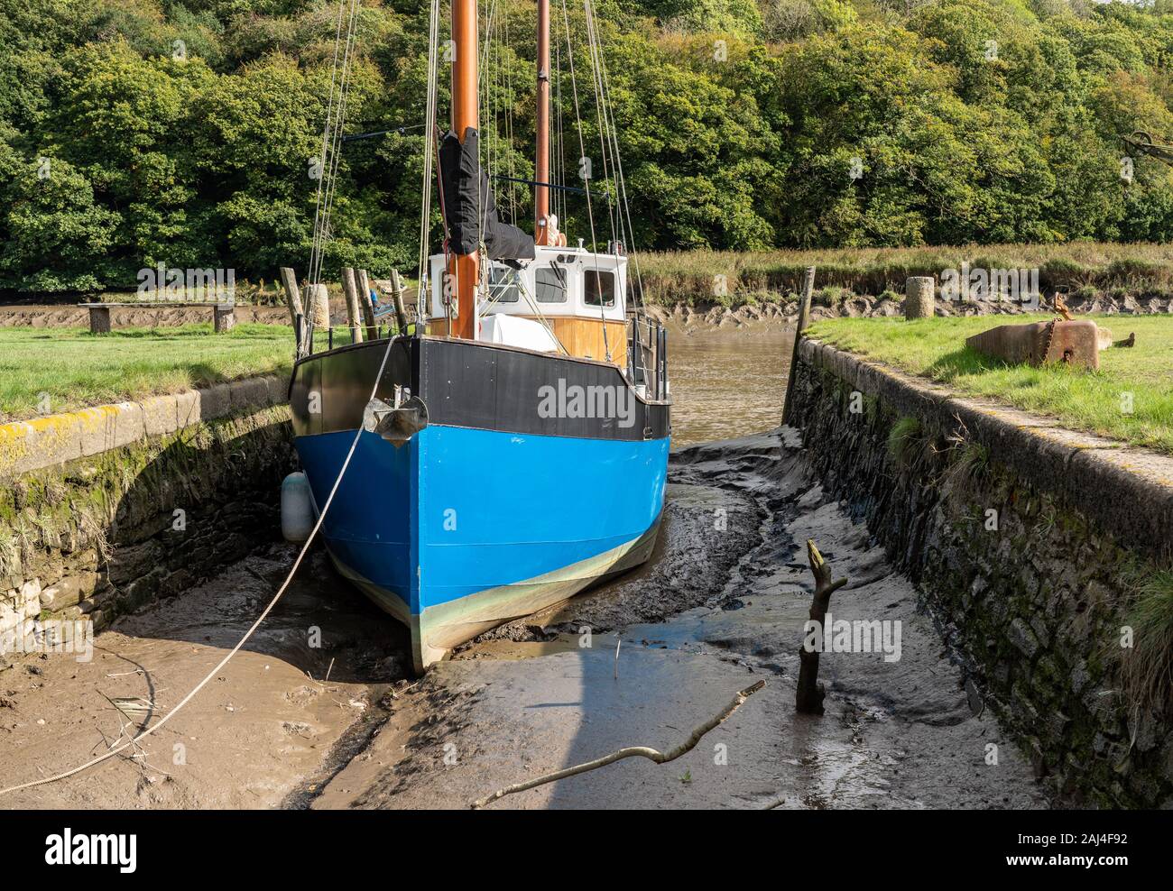 Blue fishing boat in small quay off the tidal River Tamar at Cotehele ...