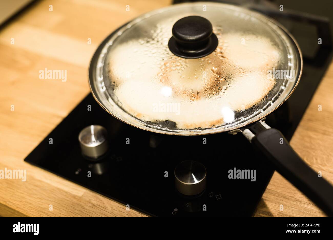 frying pan on the gas stove Stock Photo - Alamy