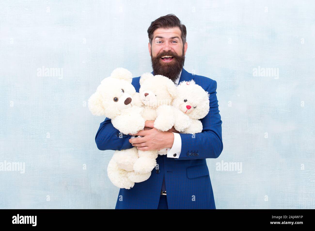 Adoption is wonderful thing. Happy man hold soft toys. Businessman ...