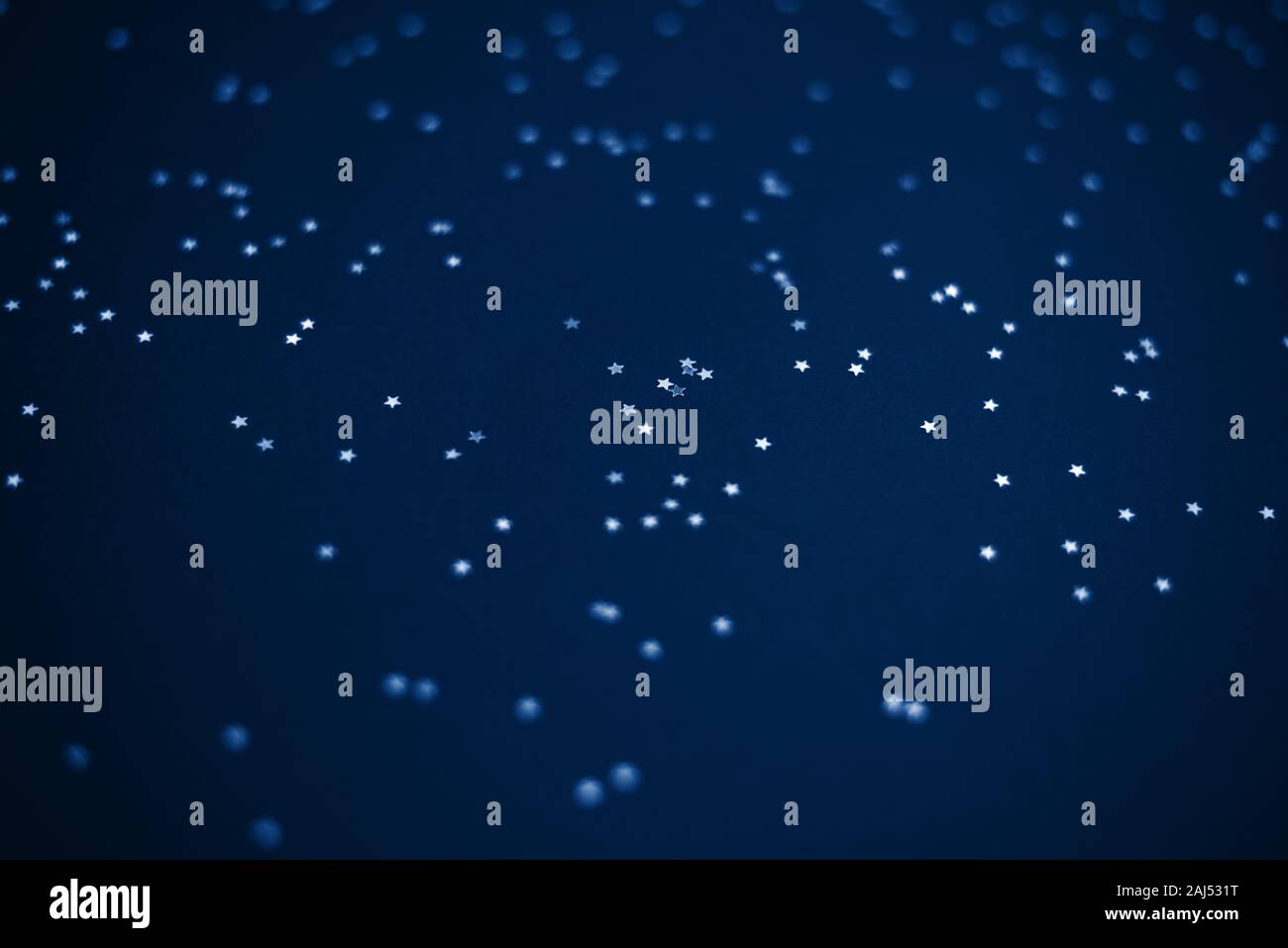 Glowing mica Silver stars confetti on blue color trendy background ...