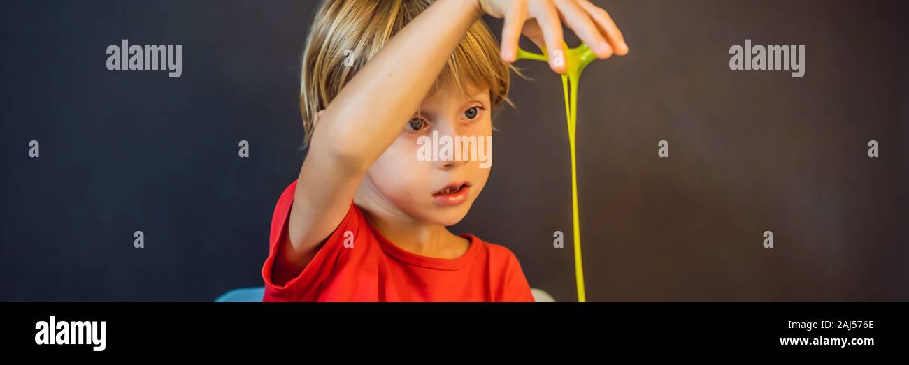 Boy playing hand made toy called slime. Child play with slime. Kid ...
