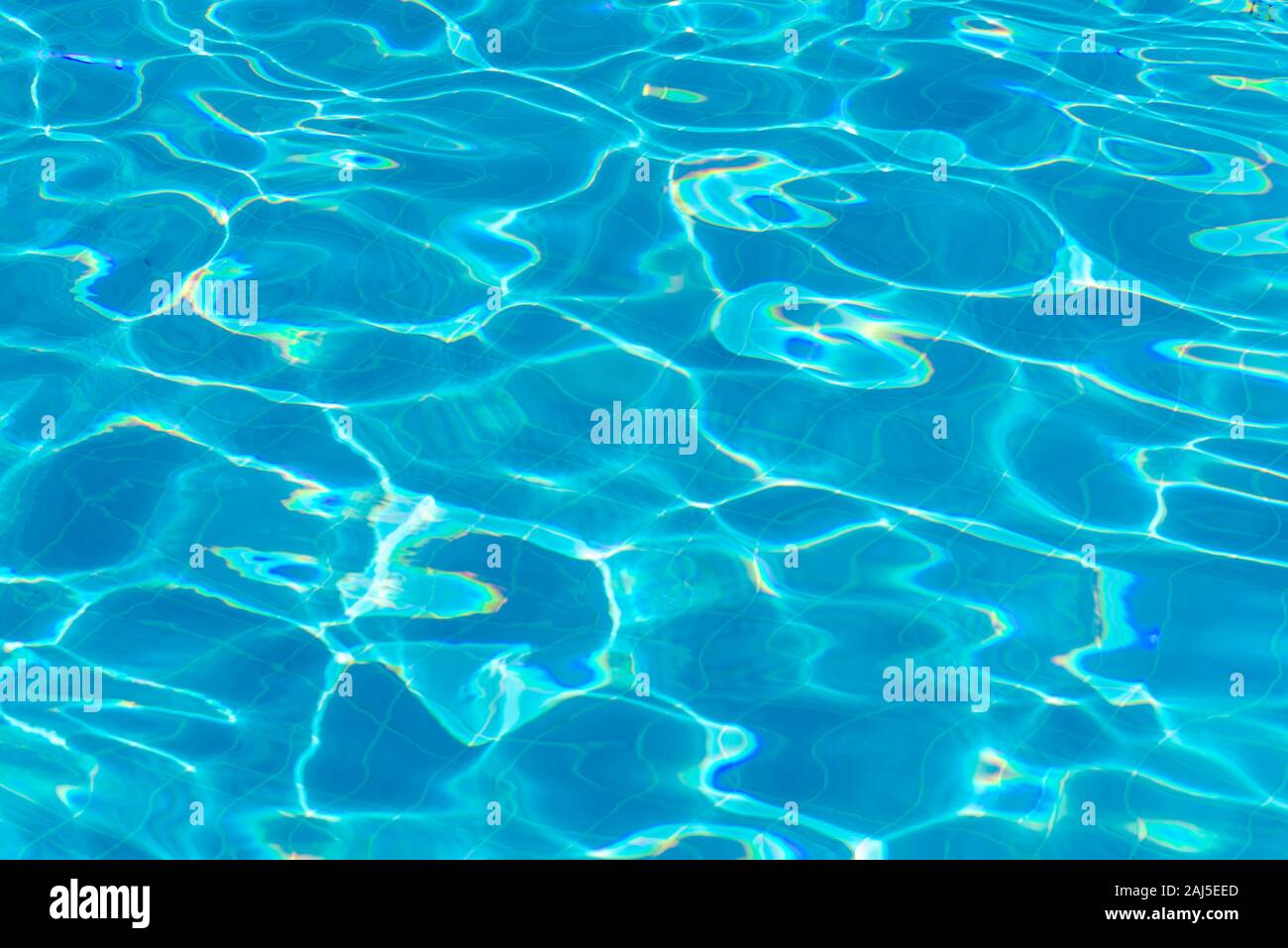 Blue bottom through the transparent water with sunspots of light in the ...