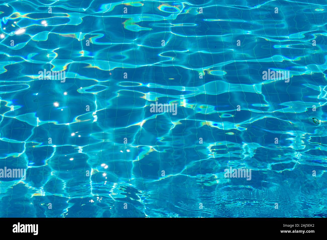 Blue bottom through the transparent water with sunspots of light in the ...