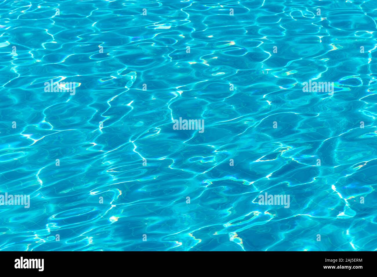 Blue bottom through the transparent water with sunspots of light in the ...