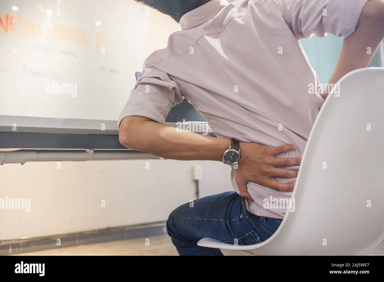 Tired millennial office worker stretch in chair Stock Photo - Alamy