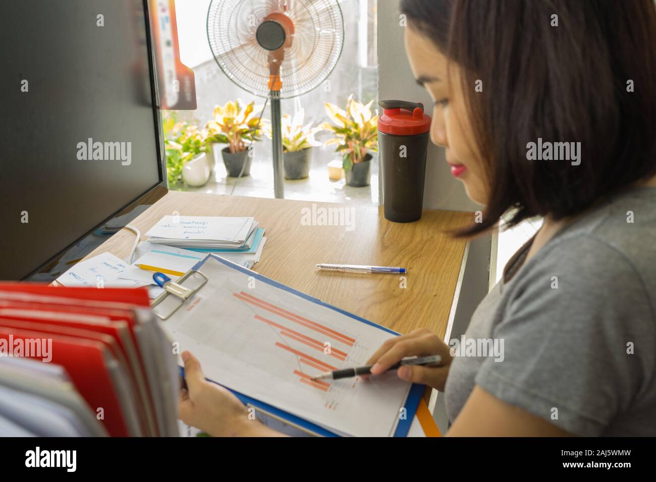 Asian office lady working on sales report at office Stock Photo - Alamy