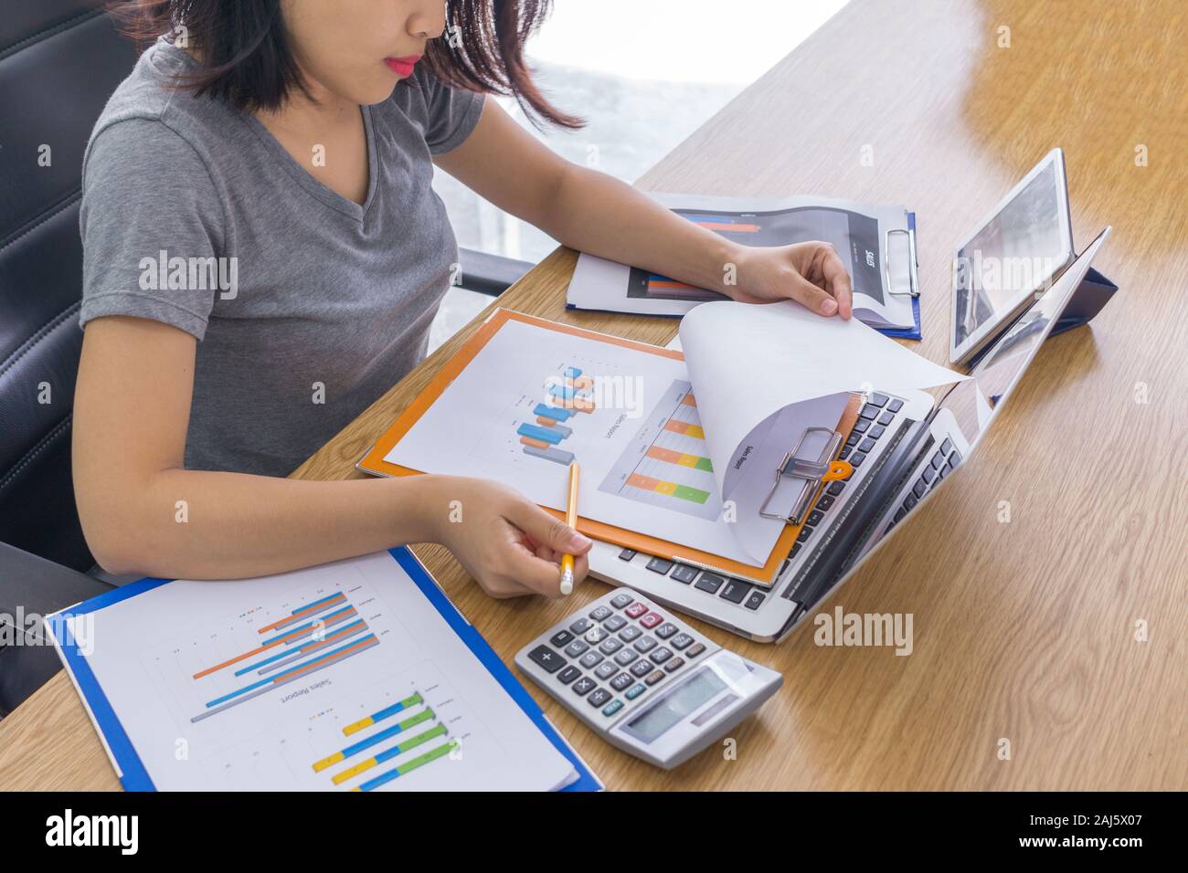 Employee work hard to finish report before dealine Stock Photo - Alamy