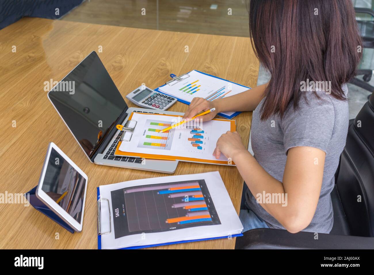 Female manager looking sales report hi-res stock photography and images ...