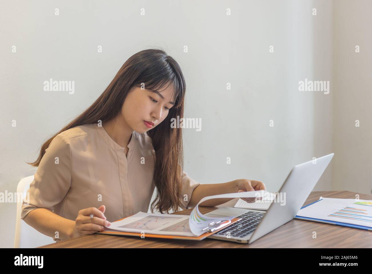 Employee reading sales reports in office Stock Photo - Alamy