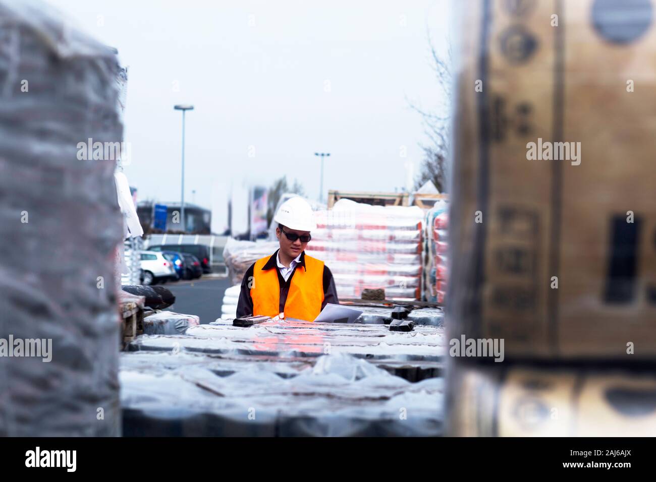 worker outside checking goods outside Stock Photo - Alamy
