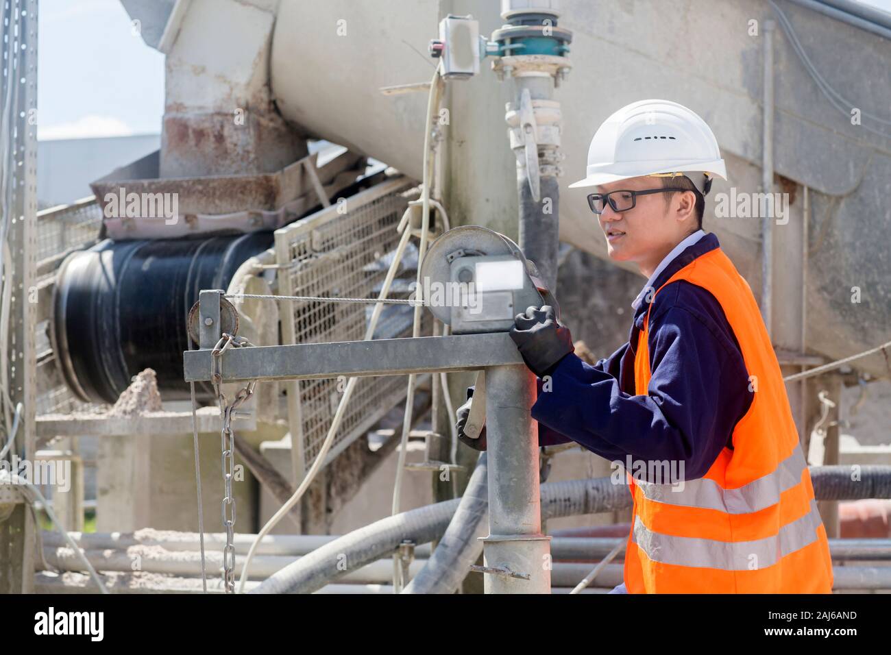 concrete worker checking machine in a concrete factory Stock Photo - Alamy