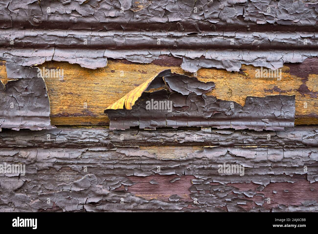 Old painted dilapidated flaky scaly wooden paint building wall brown ...