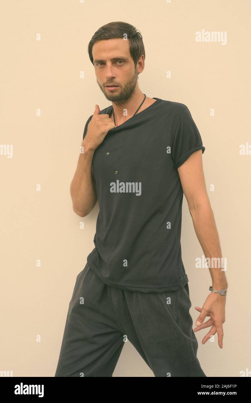 Portrait Of Handsome Man Wearing Black Shirt Against White Background