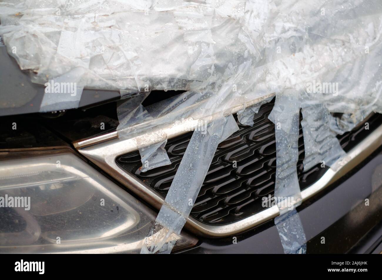 Close-up of a damage car radiator grill bonded with tape and film Stock ...