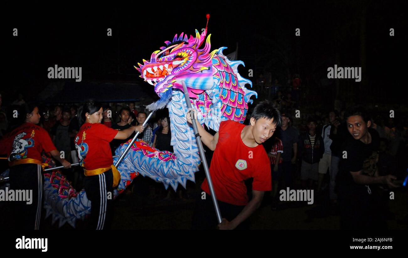 A group of artist play a dragon puppet with sticks in Chinese new year ...