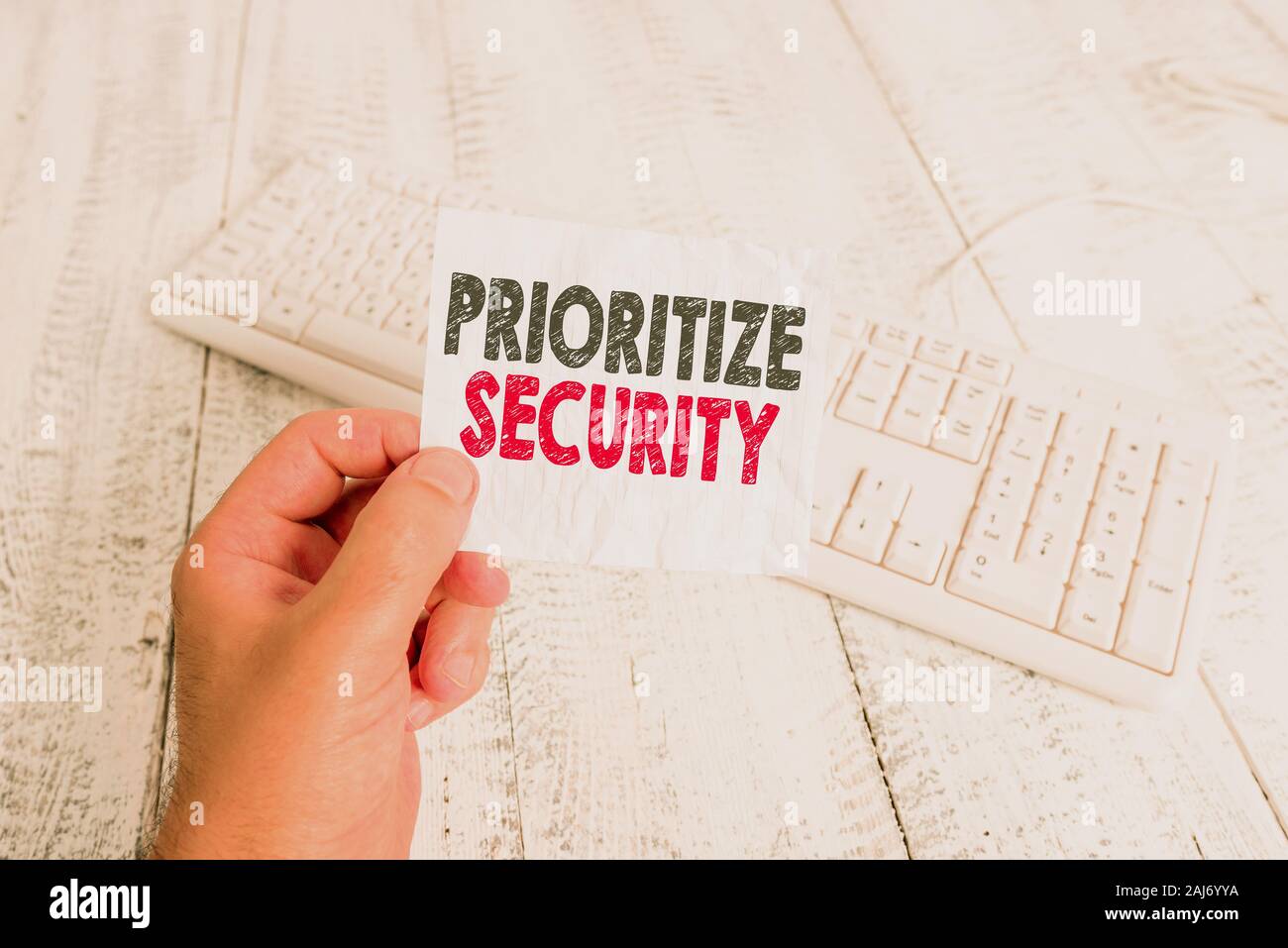 Writing note showing Prioritize Security. Business concept for ...