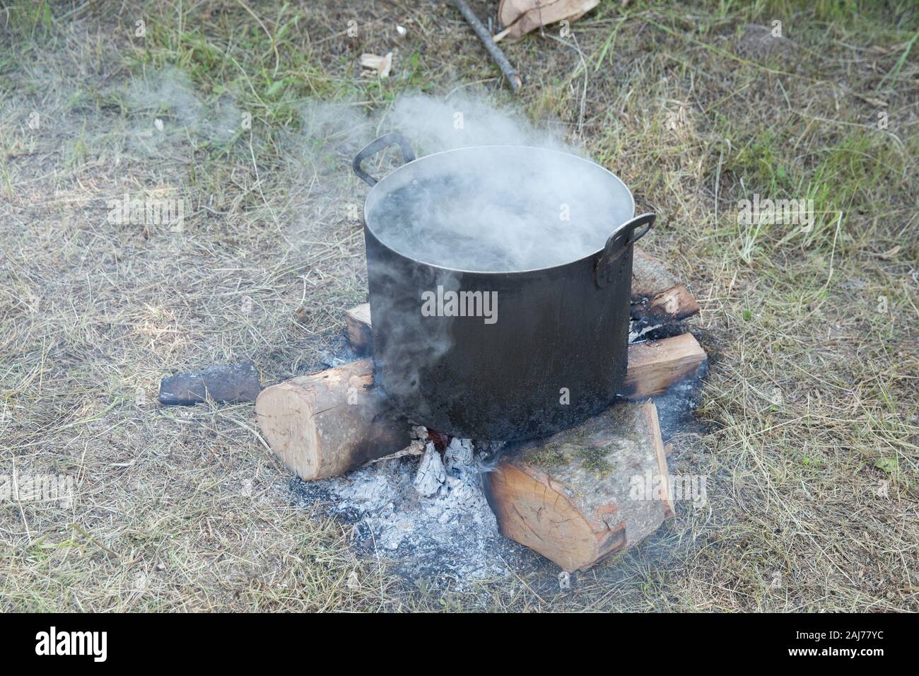 Old fashioned cooking stove with metal steel pans on a fire. Cooking ...