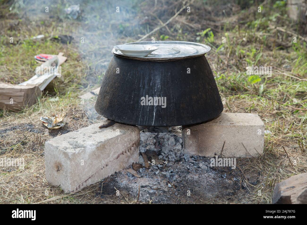 Old fashioned cooking stove with metal steel pans on a fire. Cooking ...