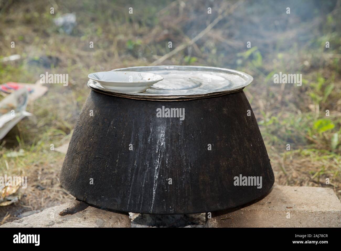 Old fashioned cooking stove with metal steel pans on a fire. Cooking ...