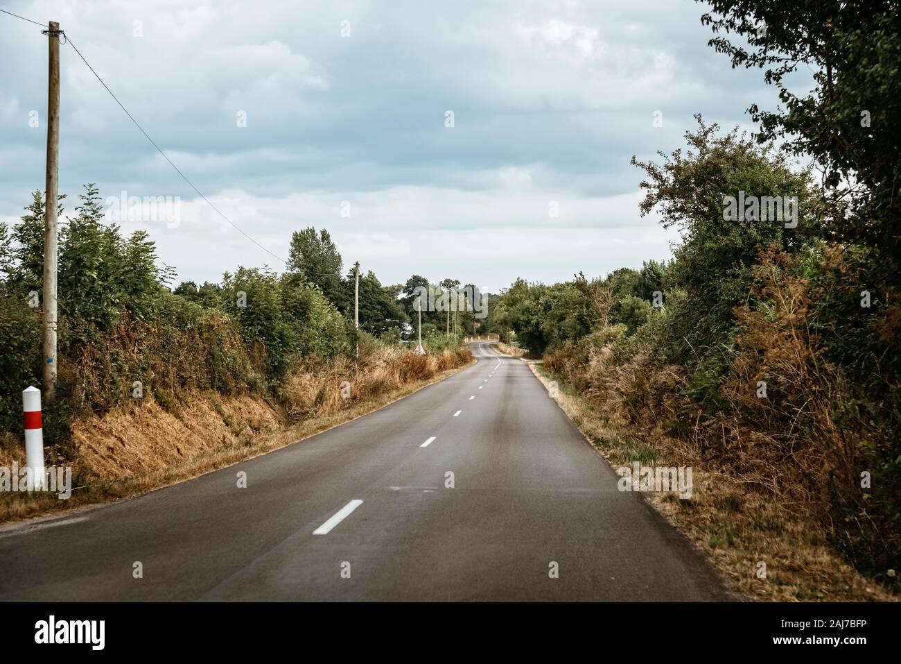 Picturesque country road in Normandy a cloudy day of summer Stock Photo ...