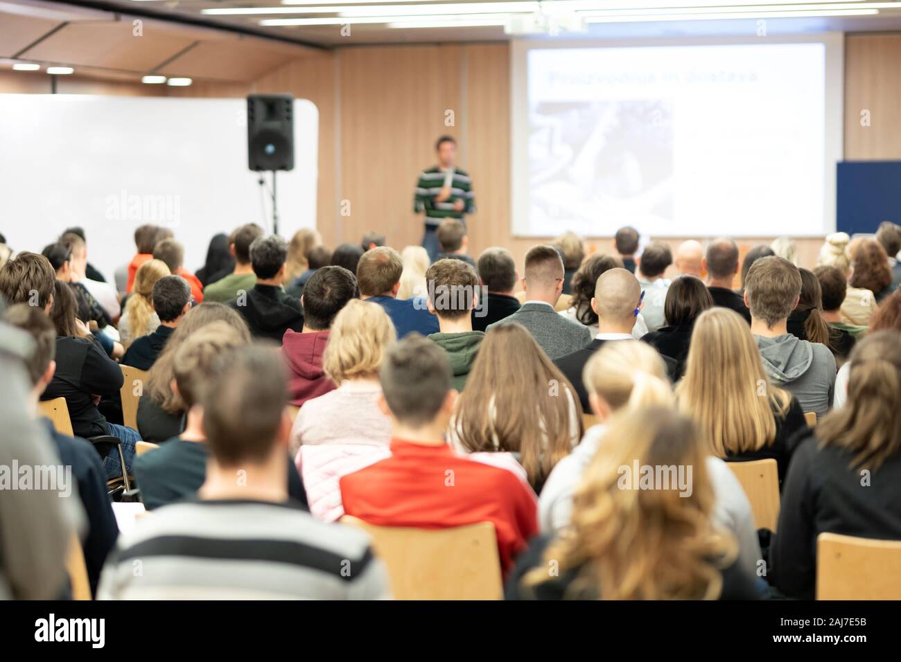 Speaker giving presentation in lecture hall at university Stock Photo ...
