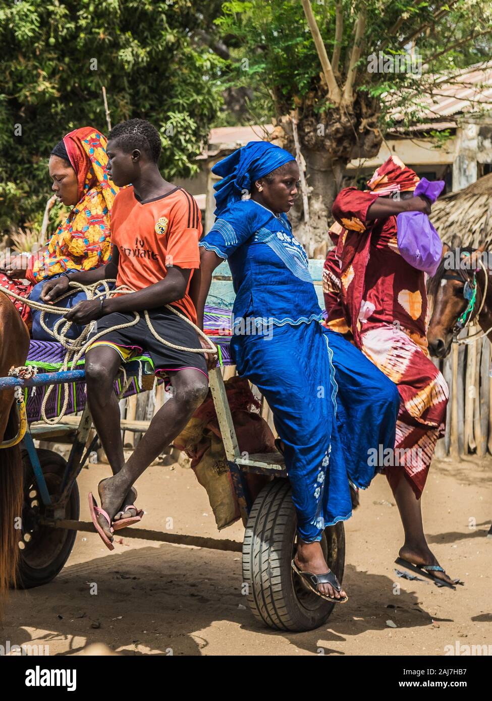 Locals getting off the cart after arriving at their destination in ...