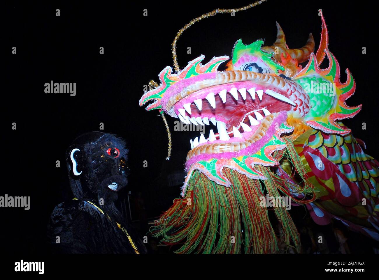 A dragon puppet meet another traditional puppet in Chinese new year ...