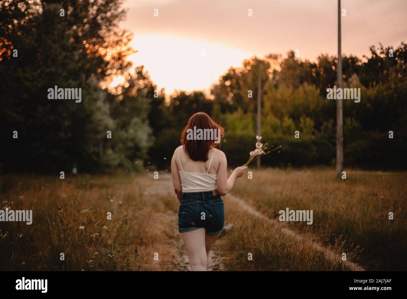 Back view of woman walking hi-res stock photography and images - Alamy