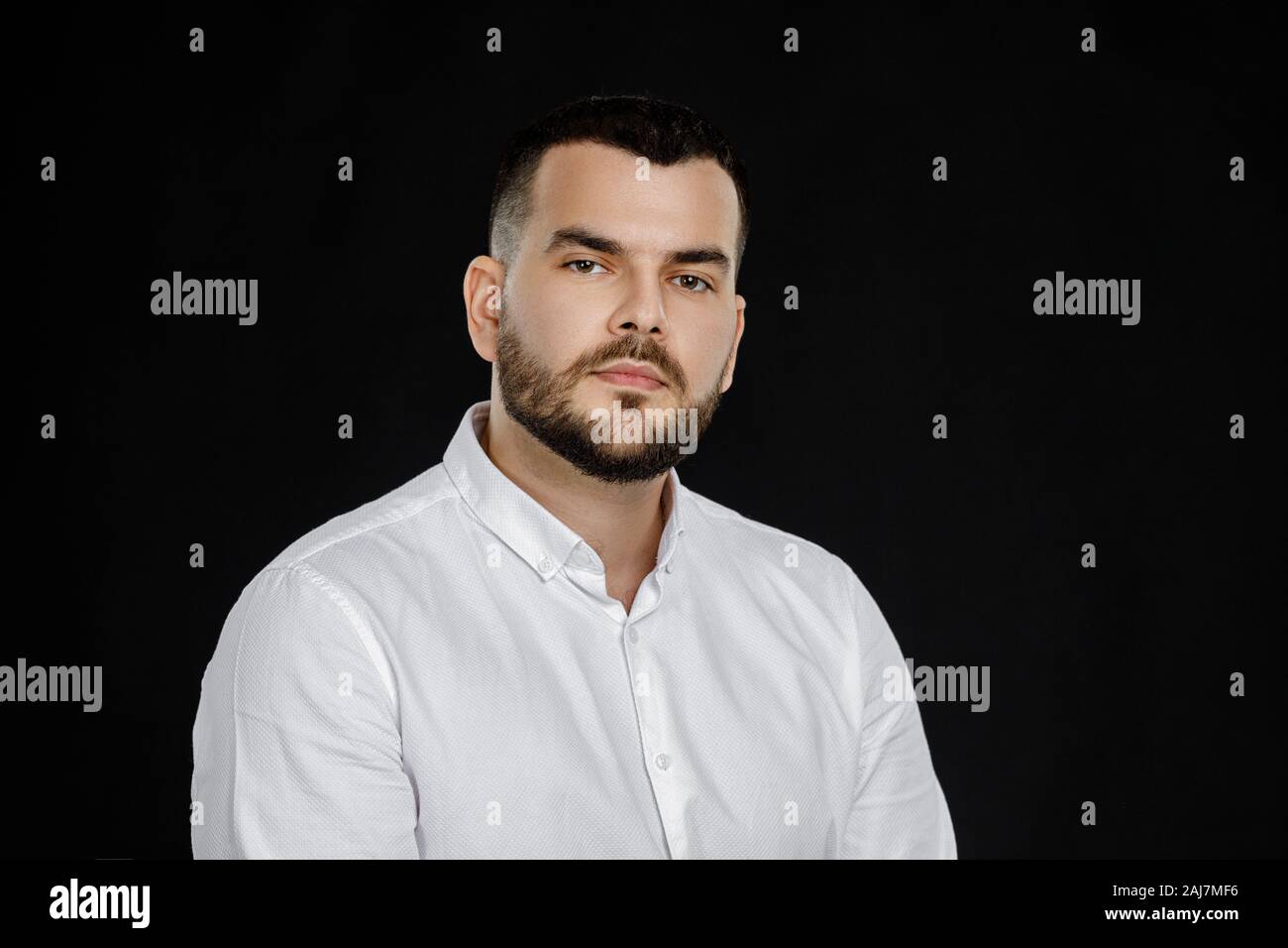 calm handsome bearded man poses in studio on black background Stock ...