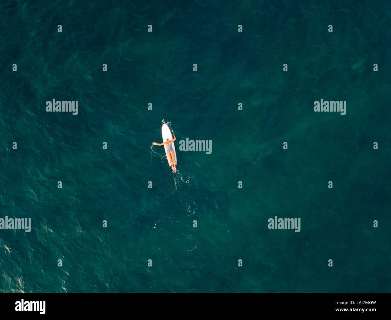 Aerial view of female surfer Stock Photo - Alamy