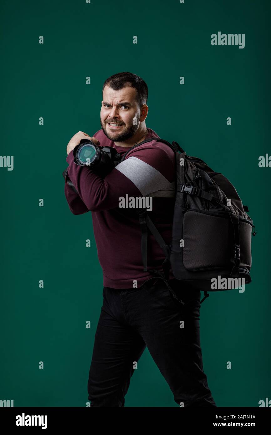 bearded man photographer takes images with professional digital photo ...