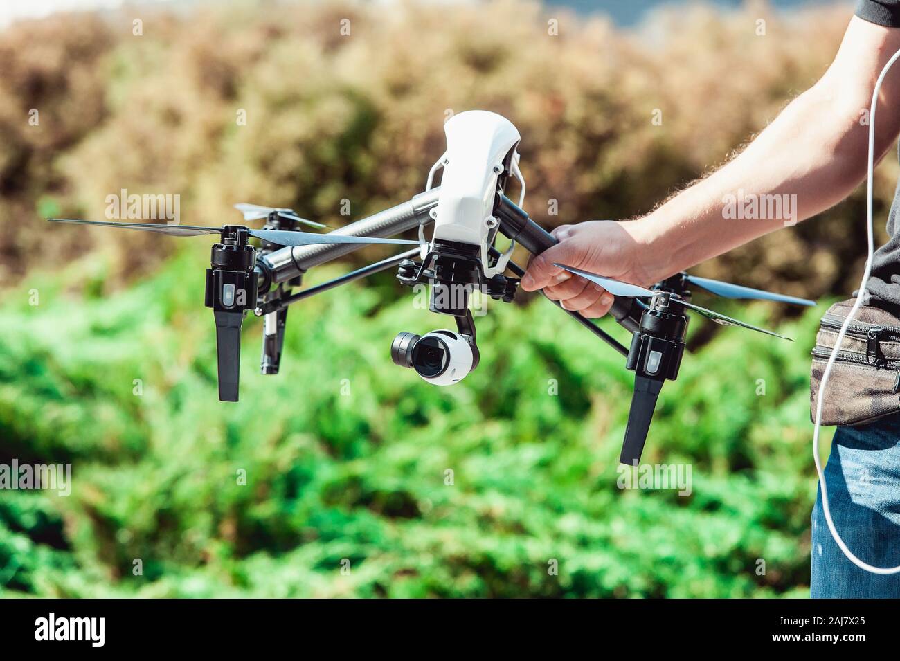Man calibrating black and white copter Stock Photo - Alamy